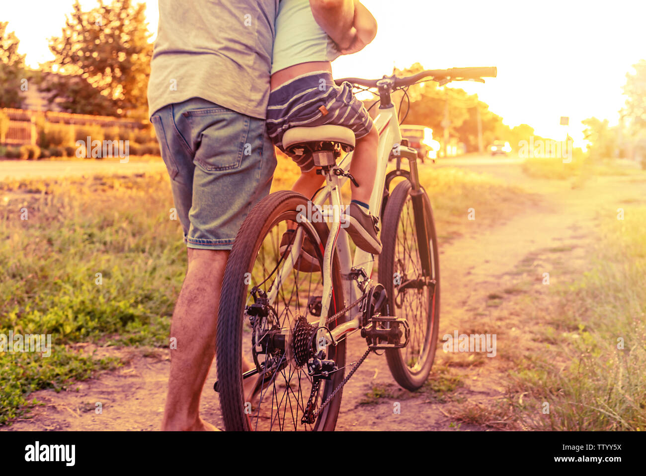 Father is teaching sun how to ride bicycle near their private house ...