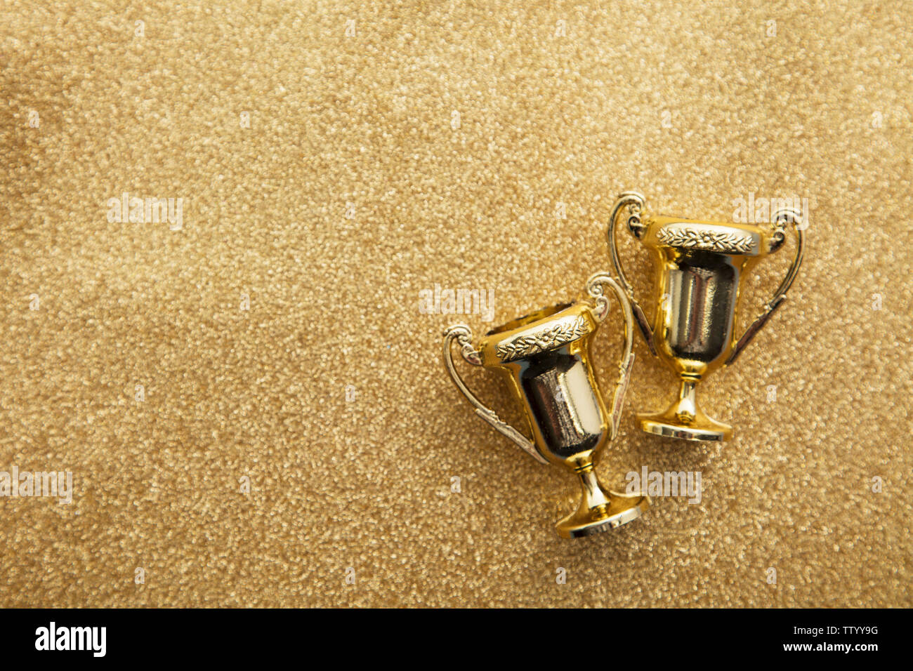 Gold winners achievement trophy on a gold glitter background Stock ...