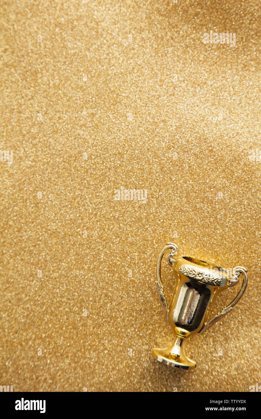 Gold winners achievement trophy on a gold glitter background Stock ...