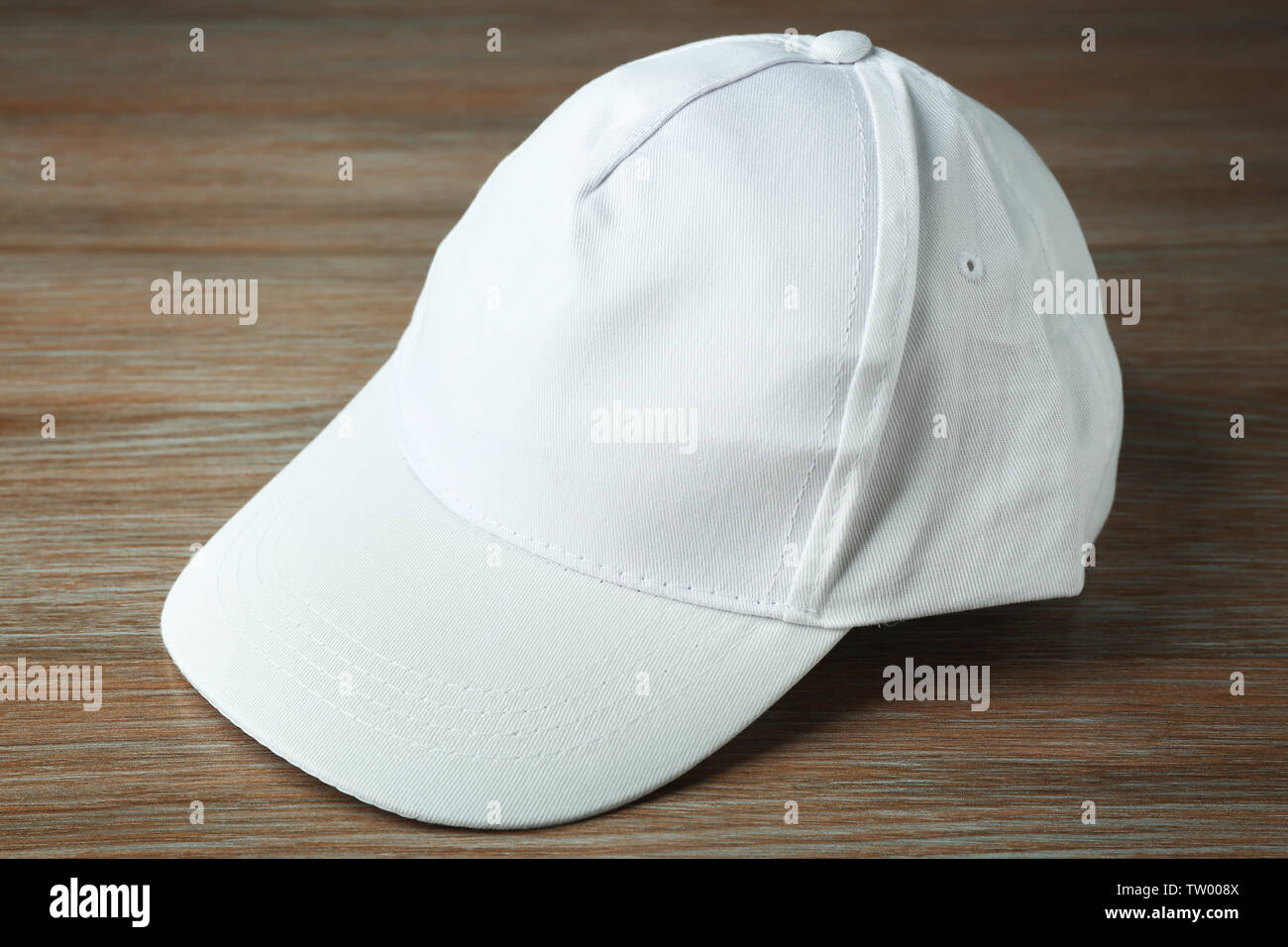 Blank white baseball cap on wooden background Stock Photo - Alamy