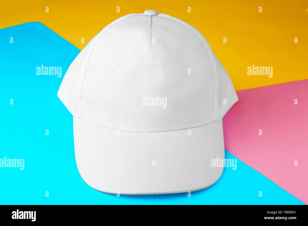 Blank white baseball cap on color paper background Stock Photo - Alamy