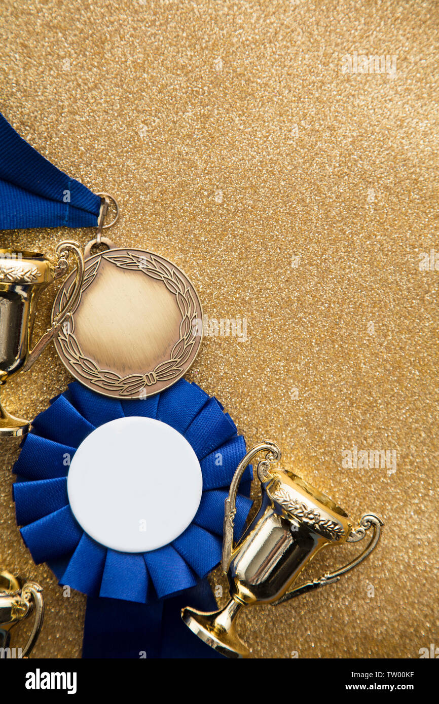 Gold winners achievement trophy on a gold glitter background Stock ...