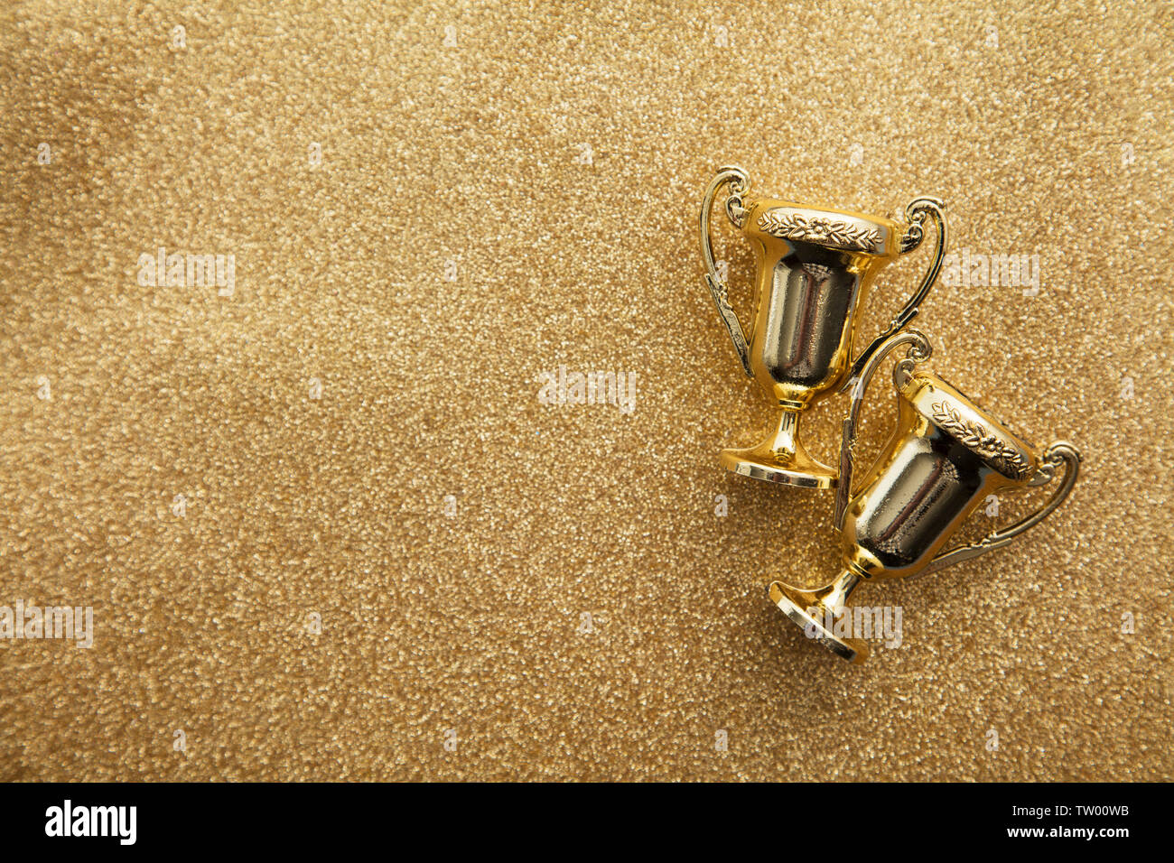 Gold winners achievement trophy on a gold glitter background Stock ...