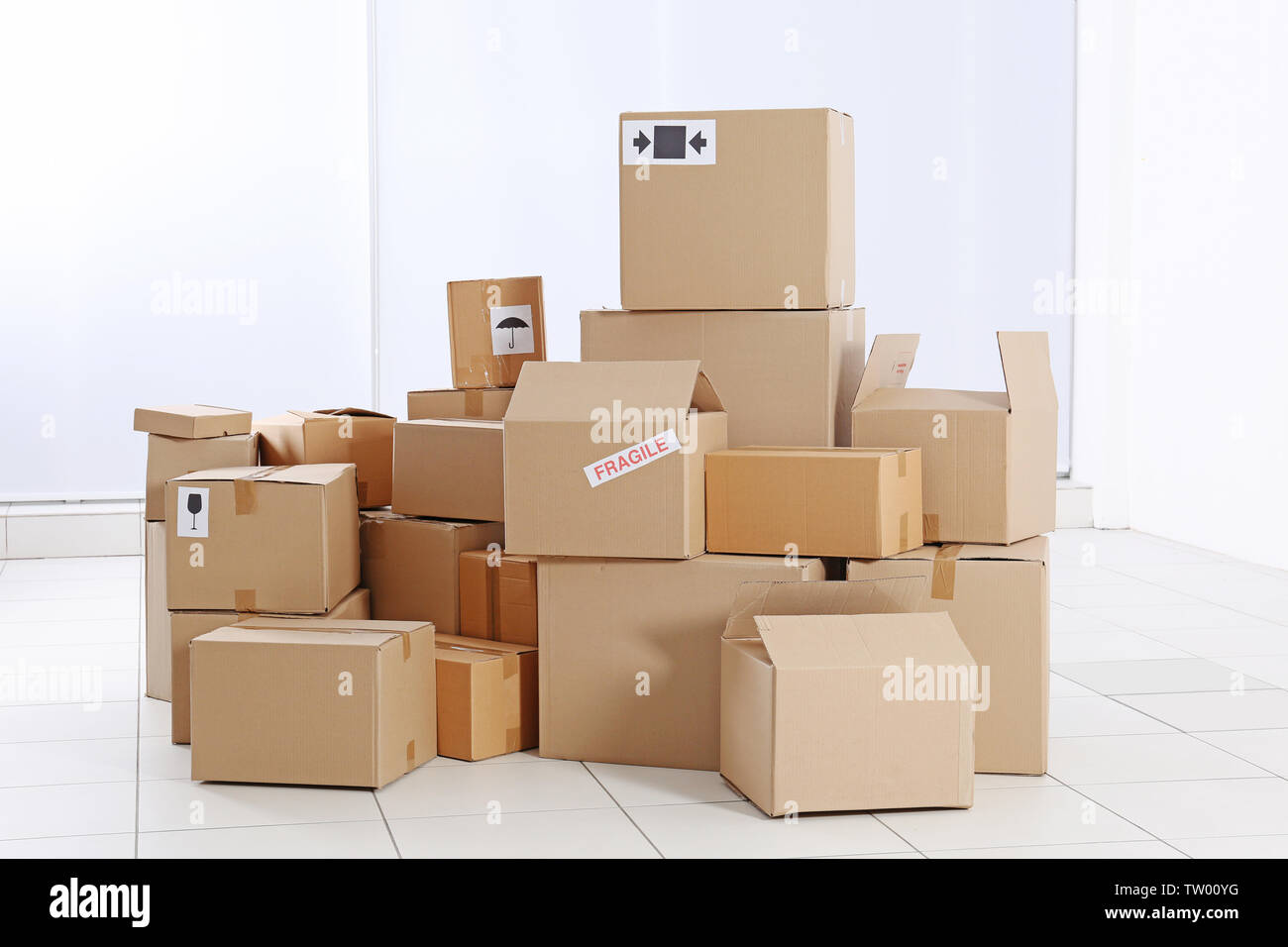 House move concept. Carton boxes on white wall background Stock Photo ...