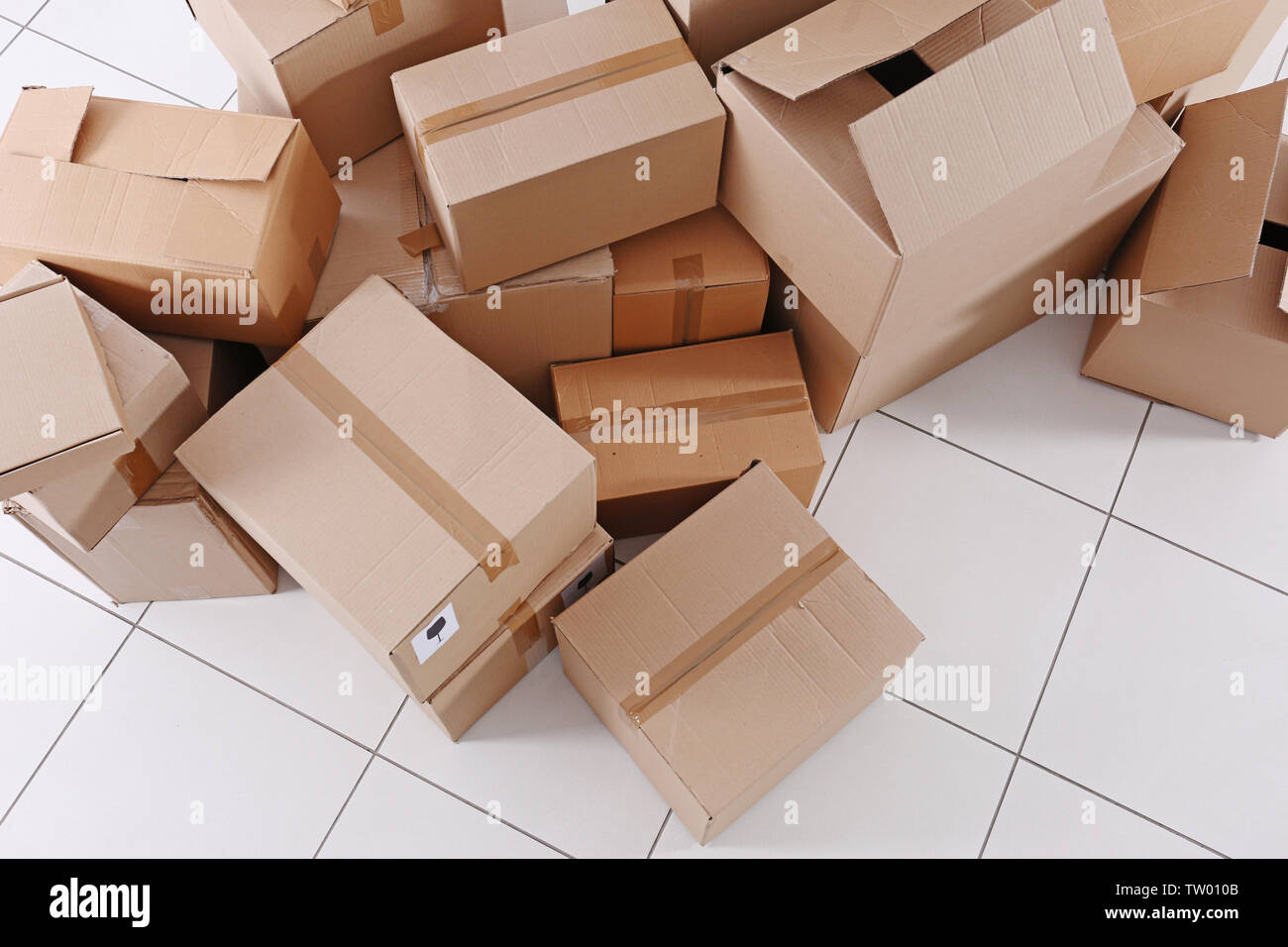 House move concept. Carton boxes on tile floor background Stock Photo ...