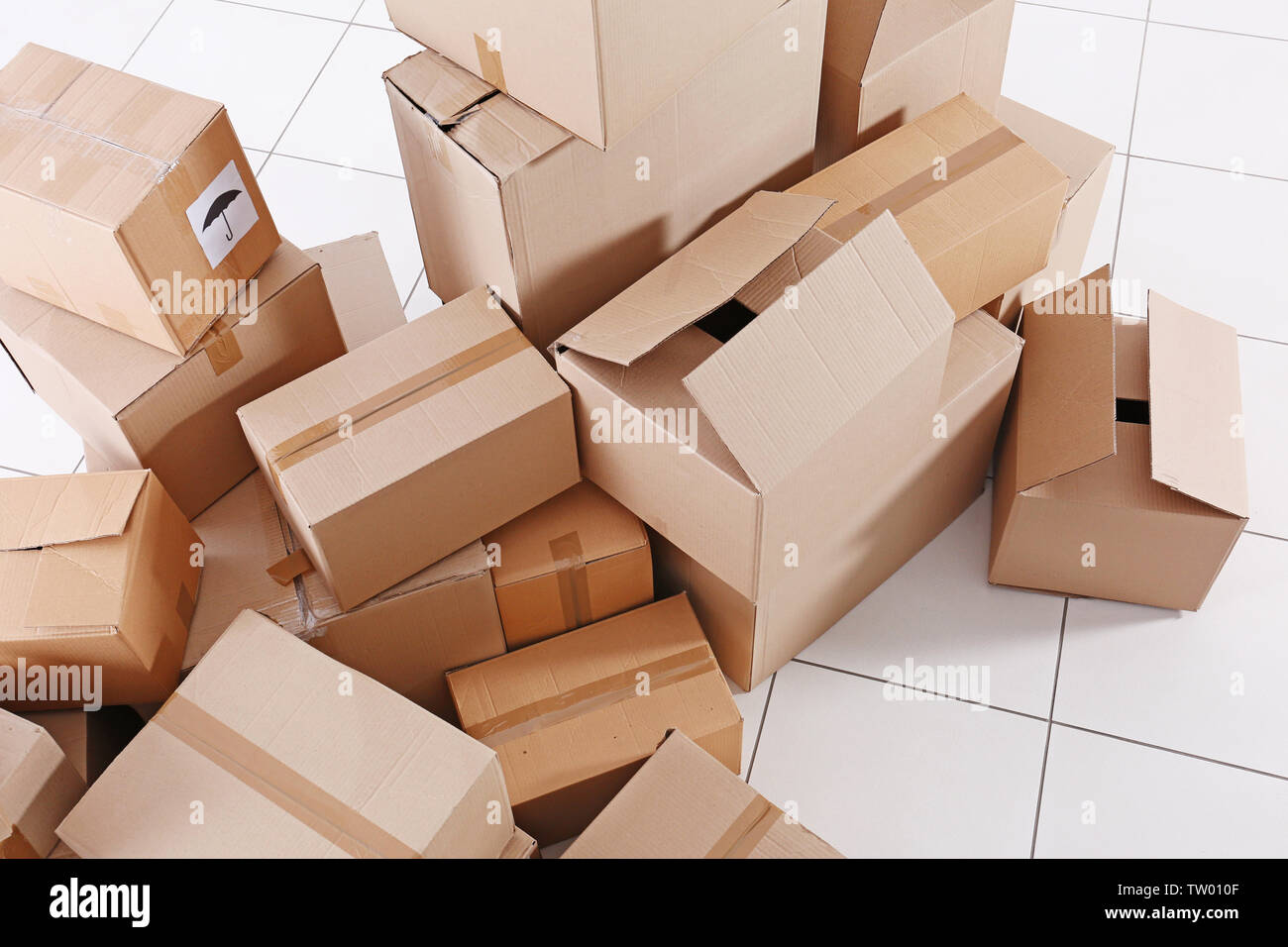 House move concept. Carton boxes on tile floor background Stock Photo ...