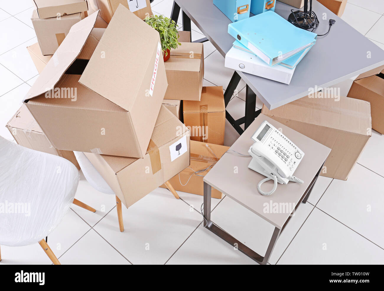 Move concept. Unpacking cardboard boxes in a new office Stock Photo - Alamy