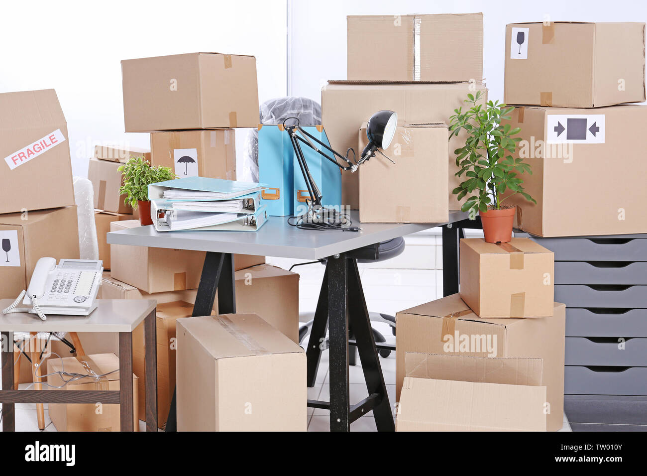 Move concept. Unpacking cardboard boxes in a new office Stock Photo - Alamy