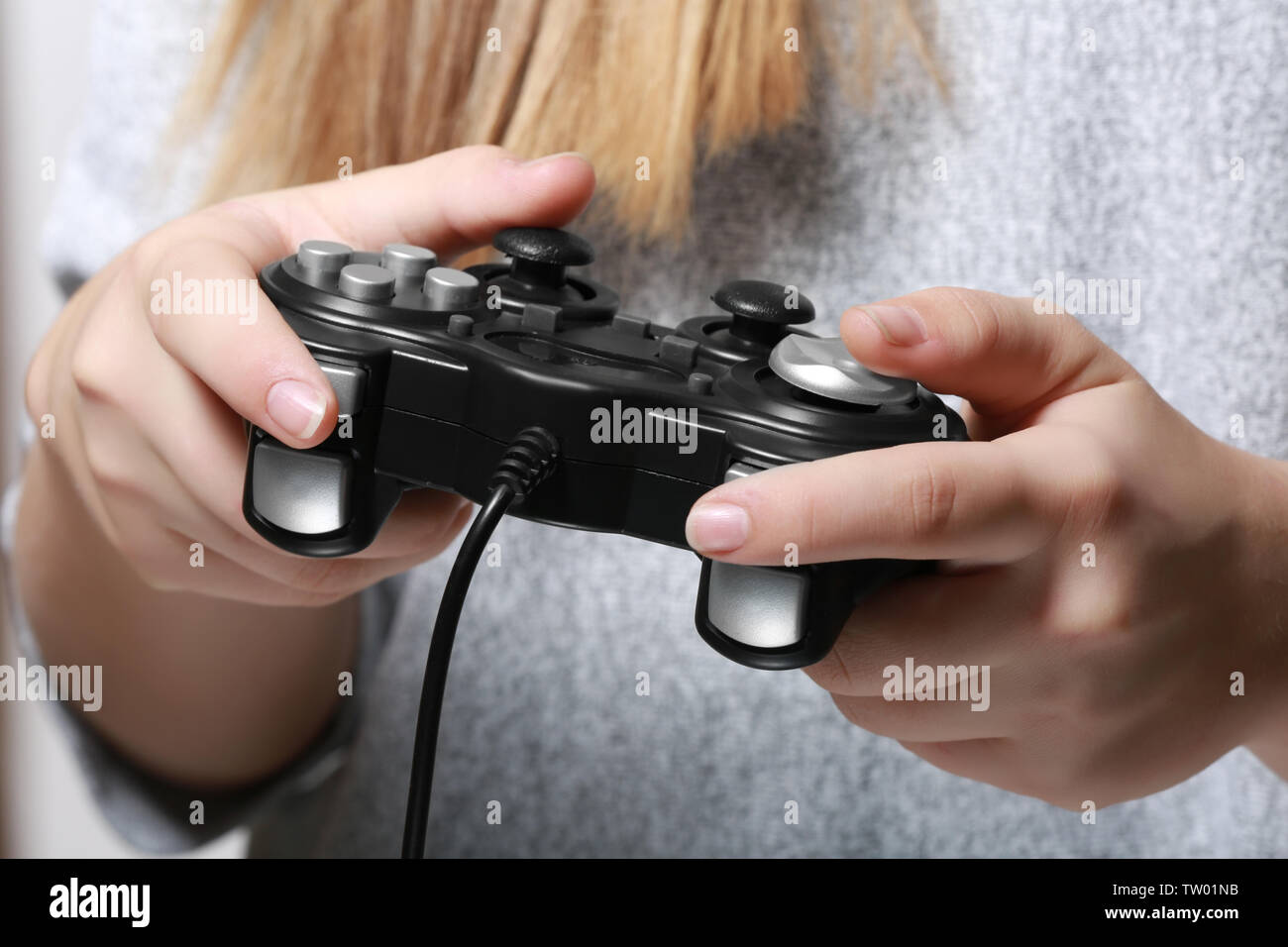 Hands of teenager holding game controller, closeup Stock Photo - Alamy
