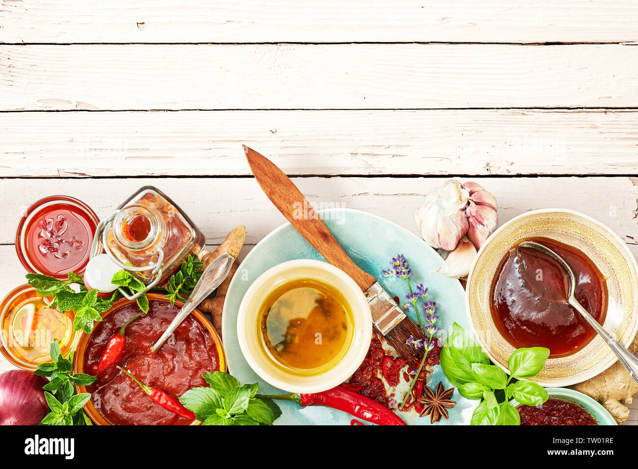 Border with a selection of sauces and marinades with fresh herbs ...