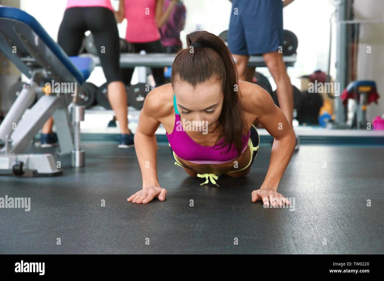 Sporty woman doing plank exercise in gym Stock Photo - Alamy
