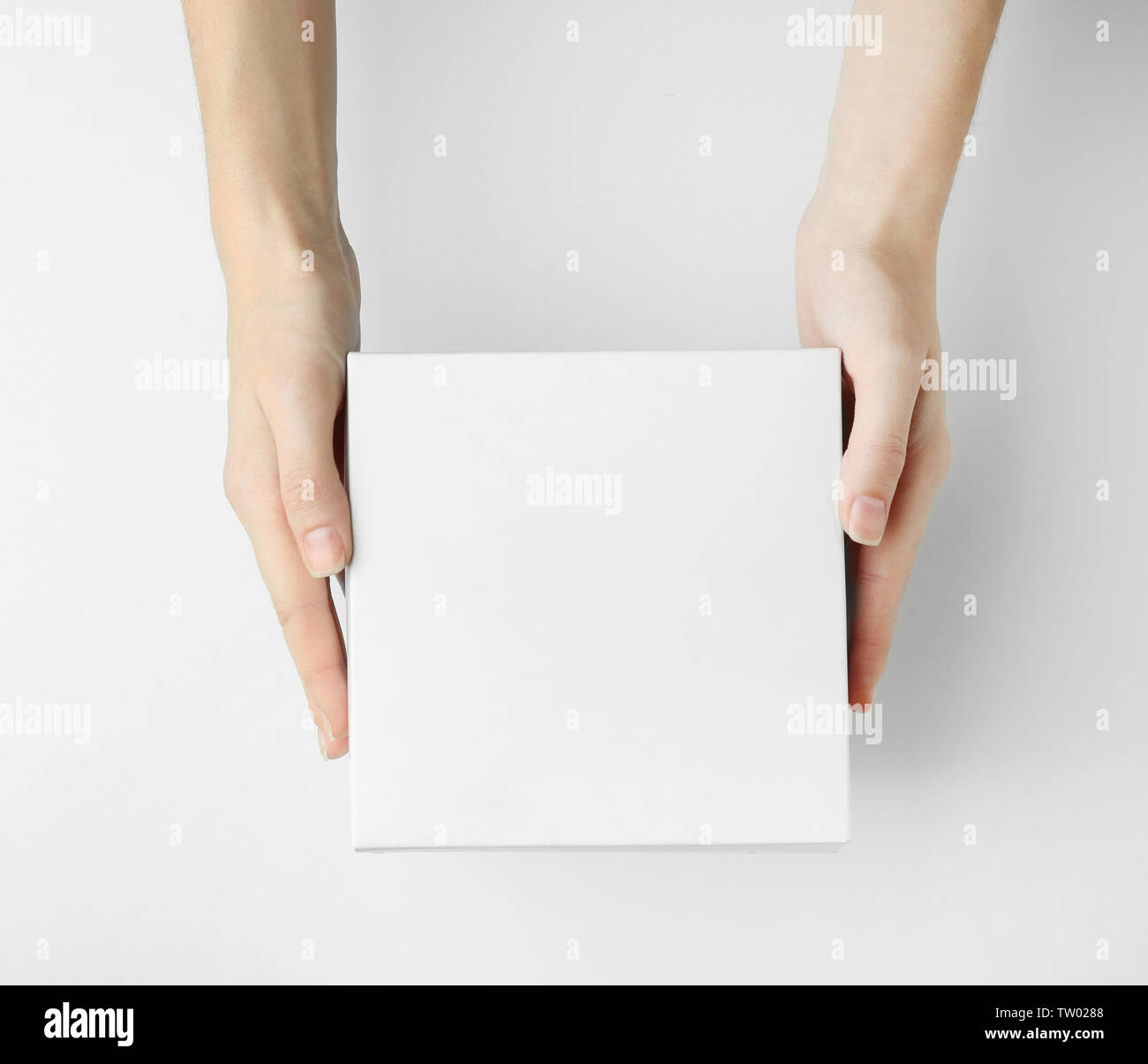 Female hands with box on white background Stock Photo - Alamy