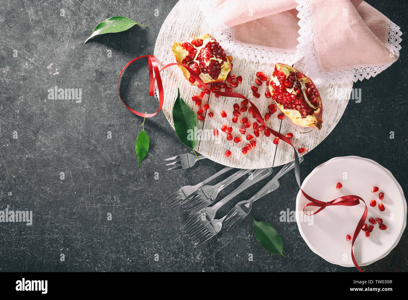Cutlery set with plates on gray table Stock Photo - Alamy