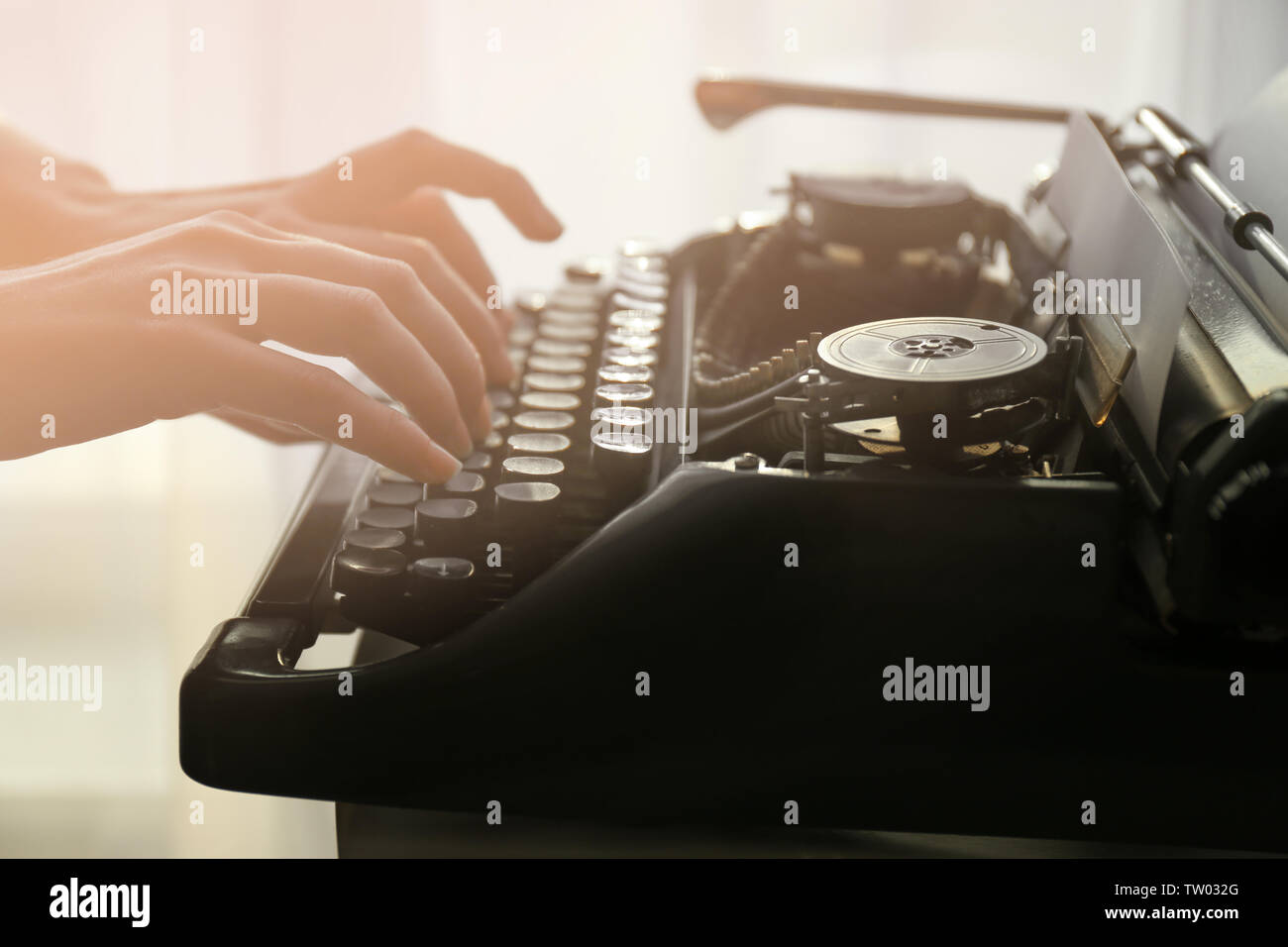 Female hands typing on typewriter, closeup Stock Photo - Alamy