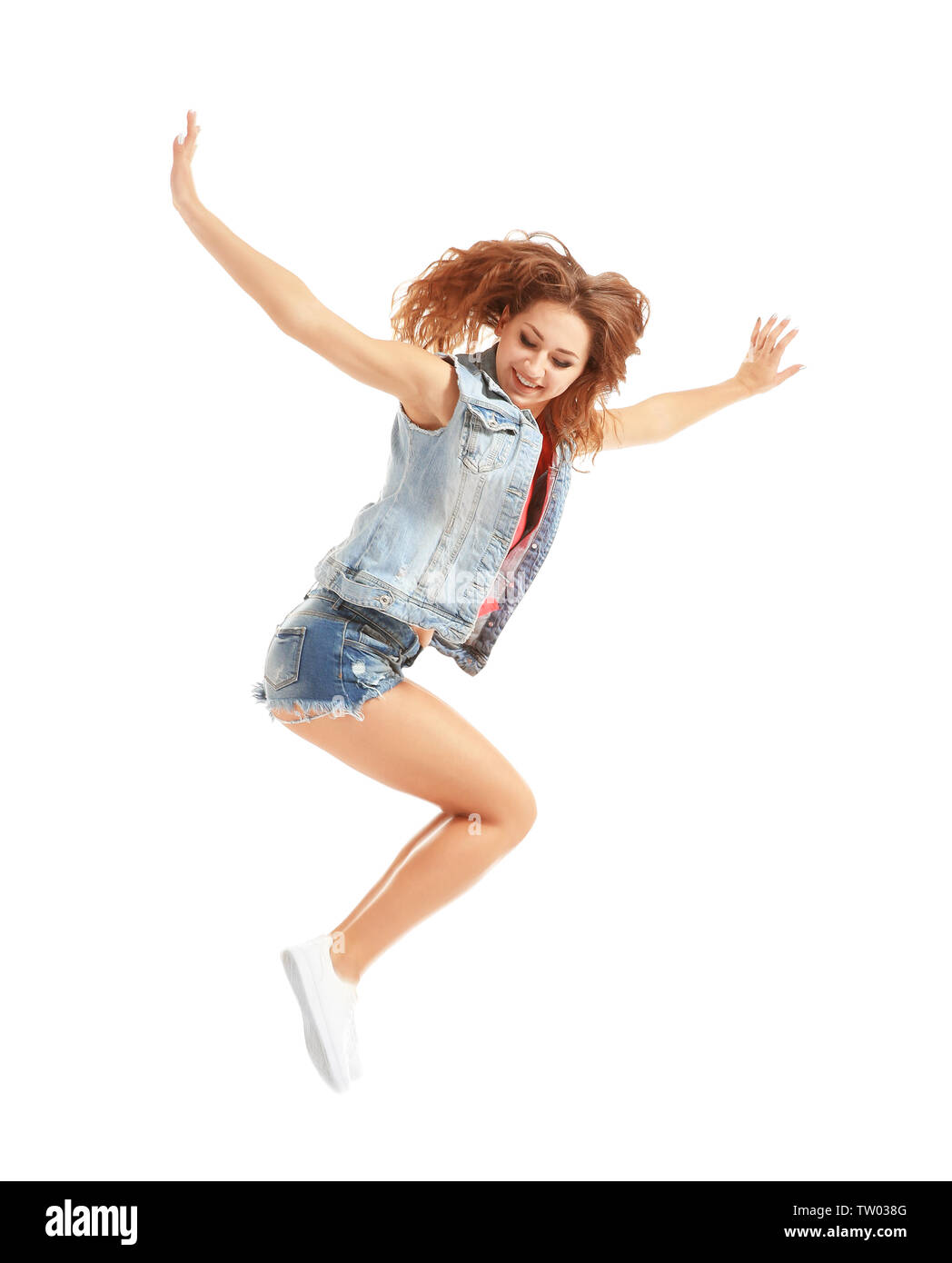 Beautiful young woman jumping on white background Stock Photo - Alamy