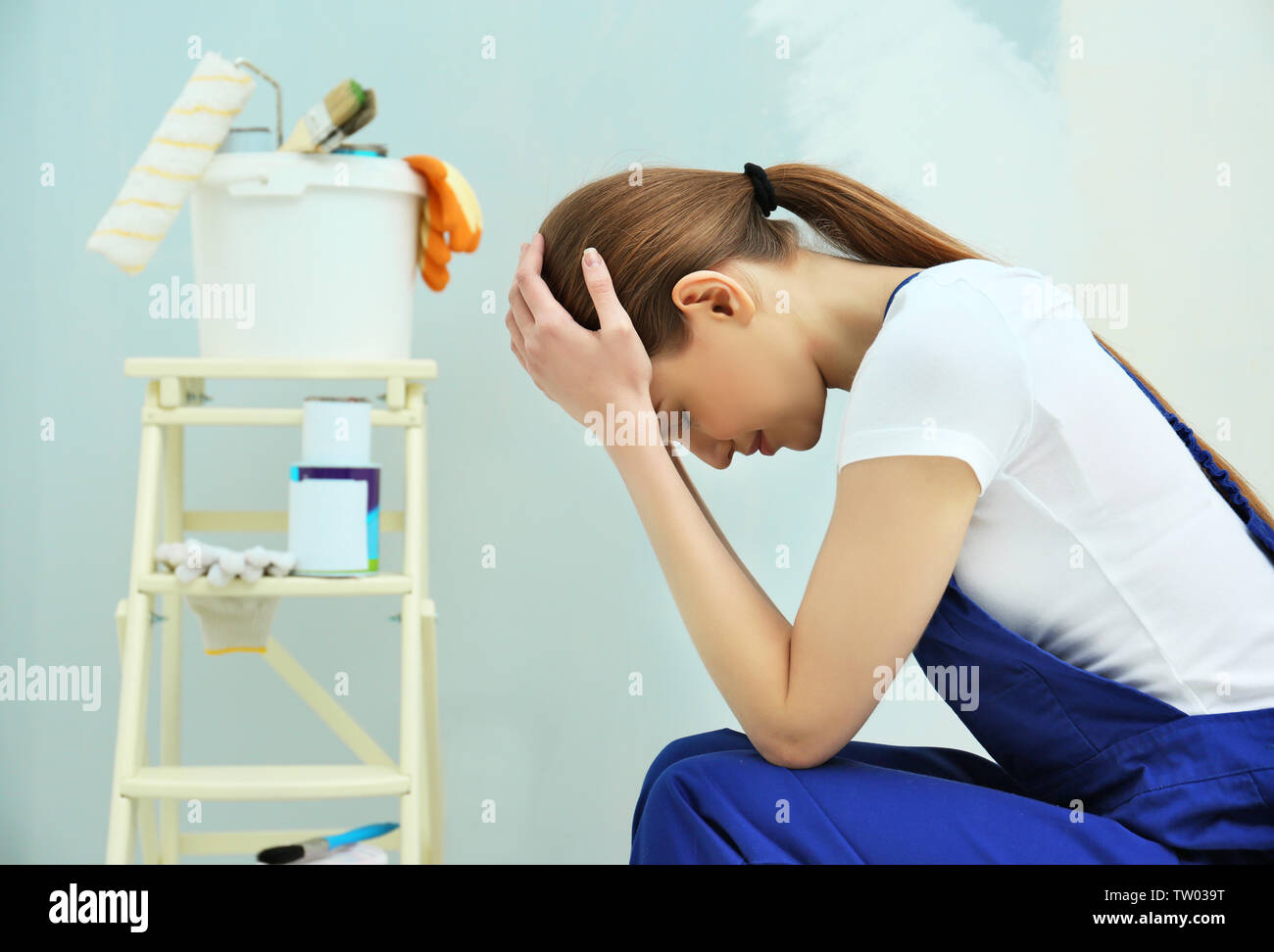 Young female decorator in empty room Stock Photo - Alamy