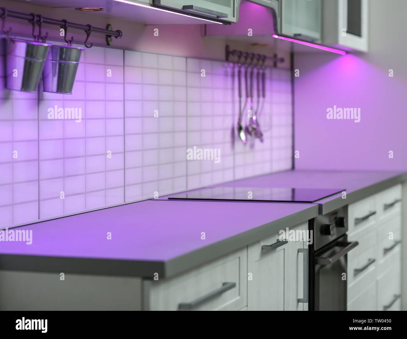 Modern kitchen interior with purple backlight Stock Photo - Alamy