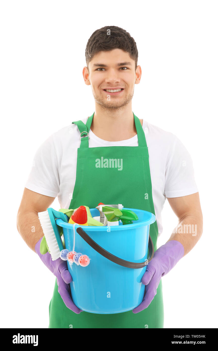 Young man holding bucket with cleaning supplies on white background ...