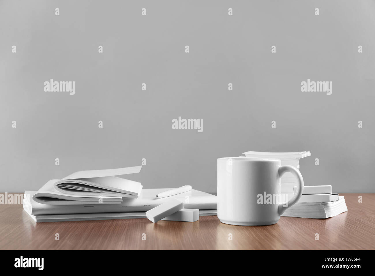 Blank goods on wooden table and grey background Stock Photo - Alamy