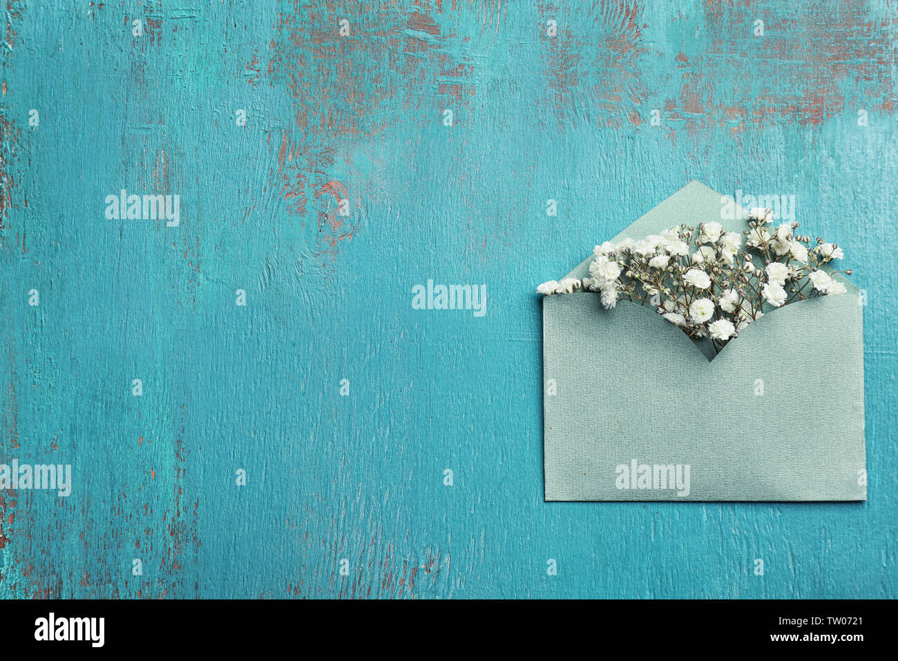 Decorative envelope with beautiful flowers on blue textured background ...