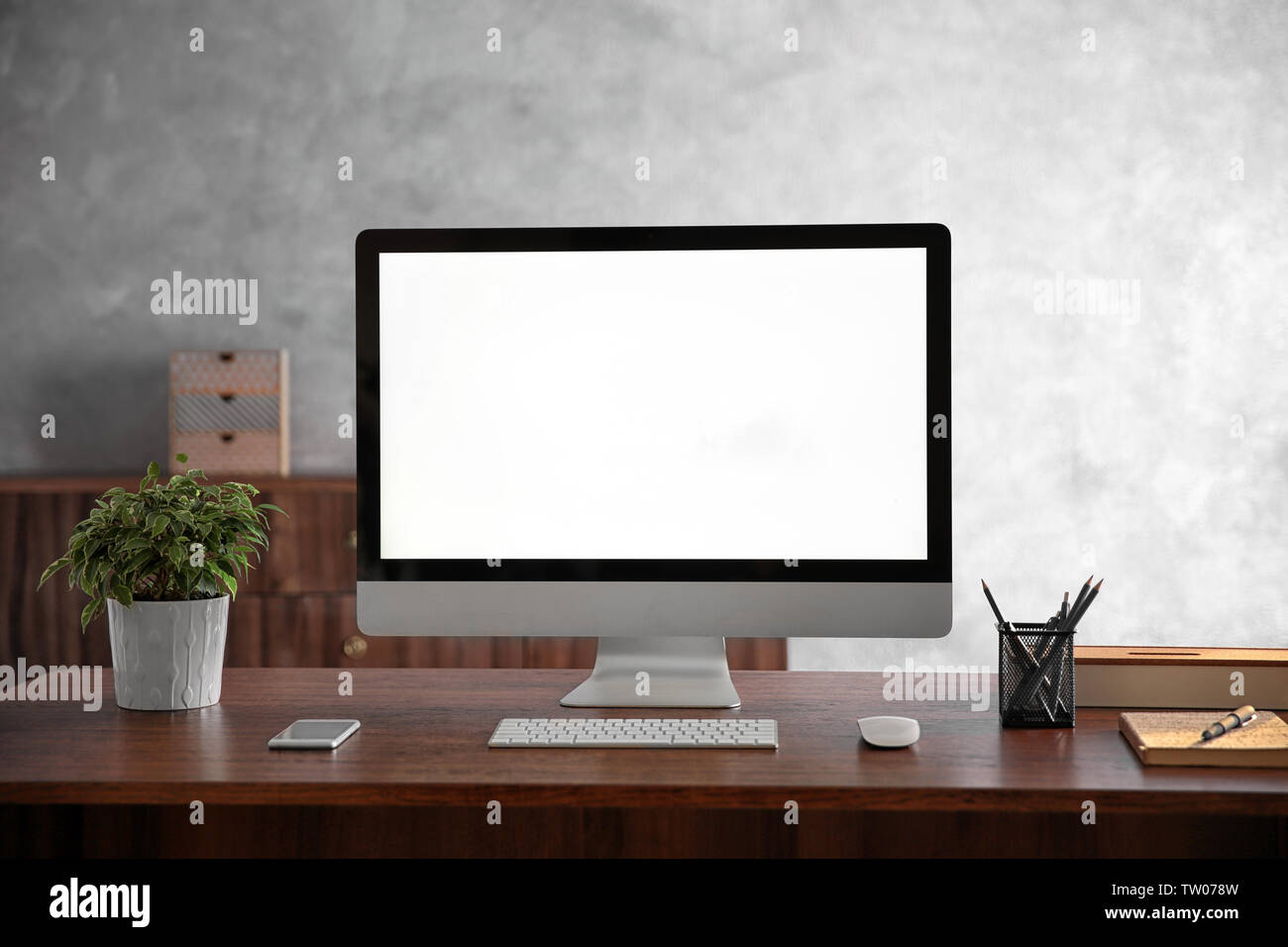 Modern computer monitor on wooden desk Stock Photo - Alamy