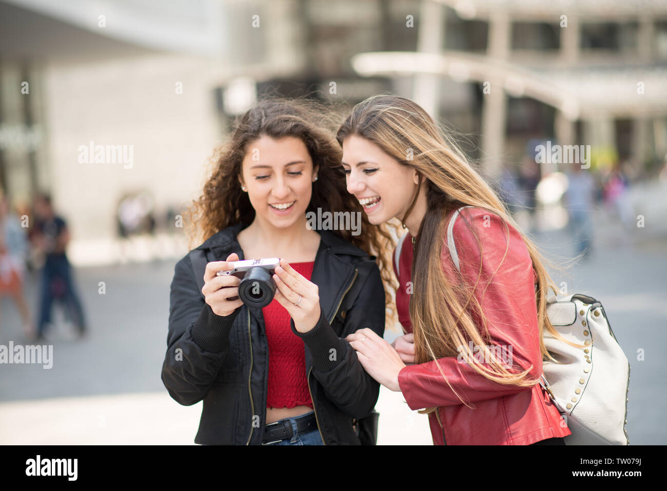 Women friends using a camera Stock Photo - Alamy