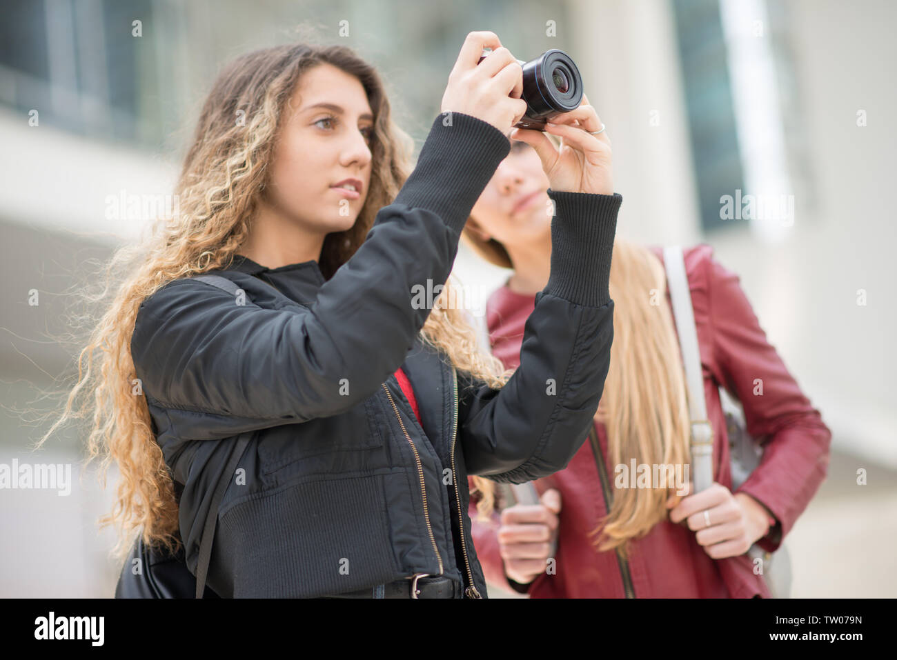 Women friends using a camera Stock Photo - Alamy