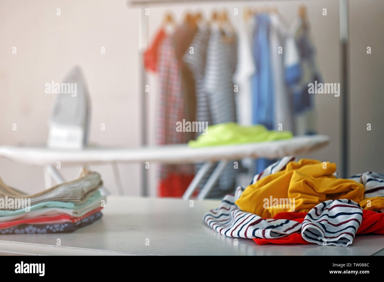 Clean clothes on table at home Stock Photo - Alamy