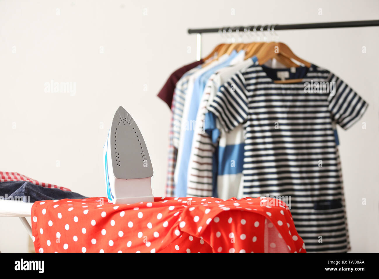 Modern iron and clean clothes on board Stock Photo - Alamy