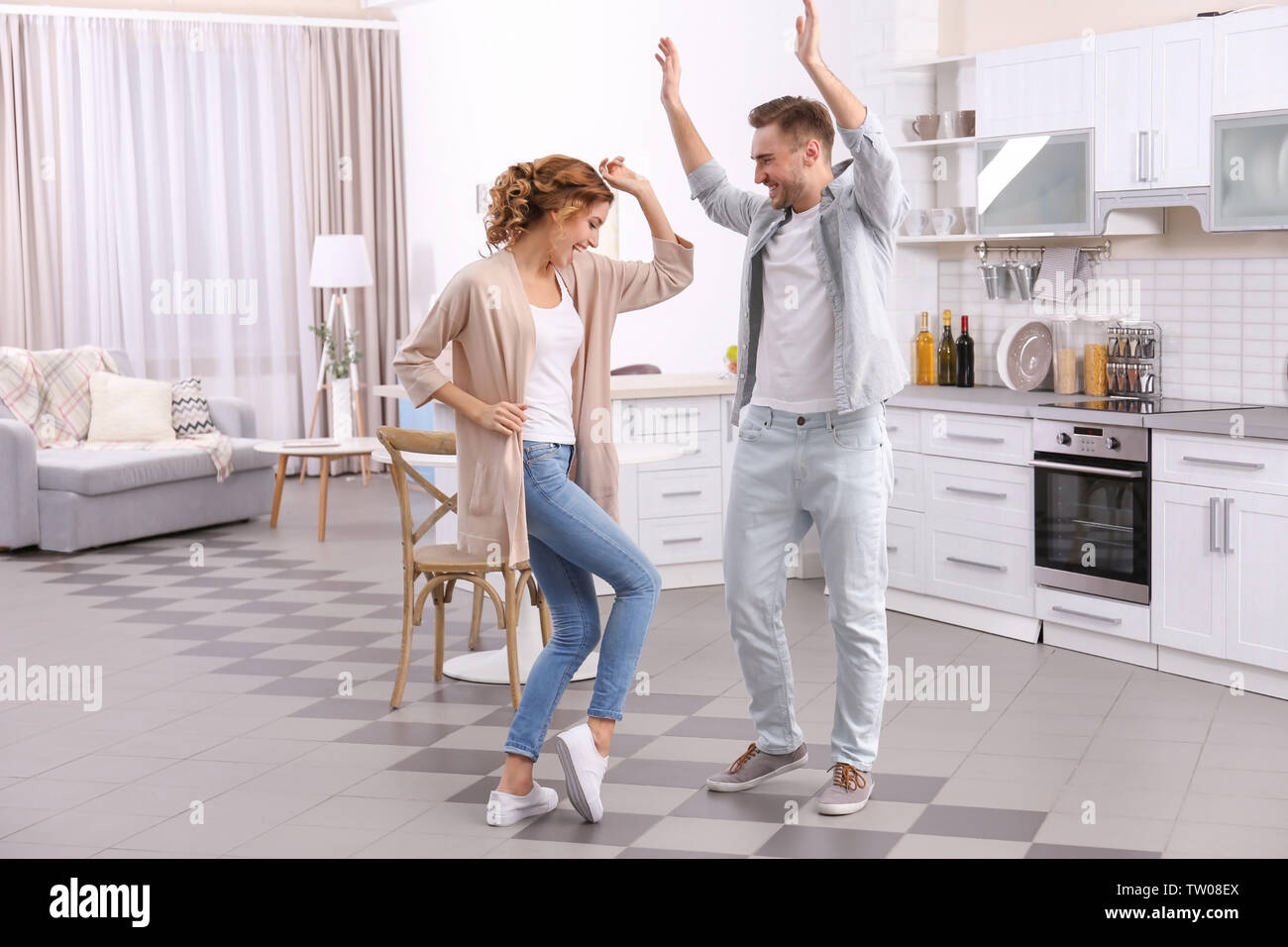 Cute young couple dancing at home Stock Photo - Alamy