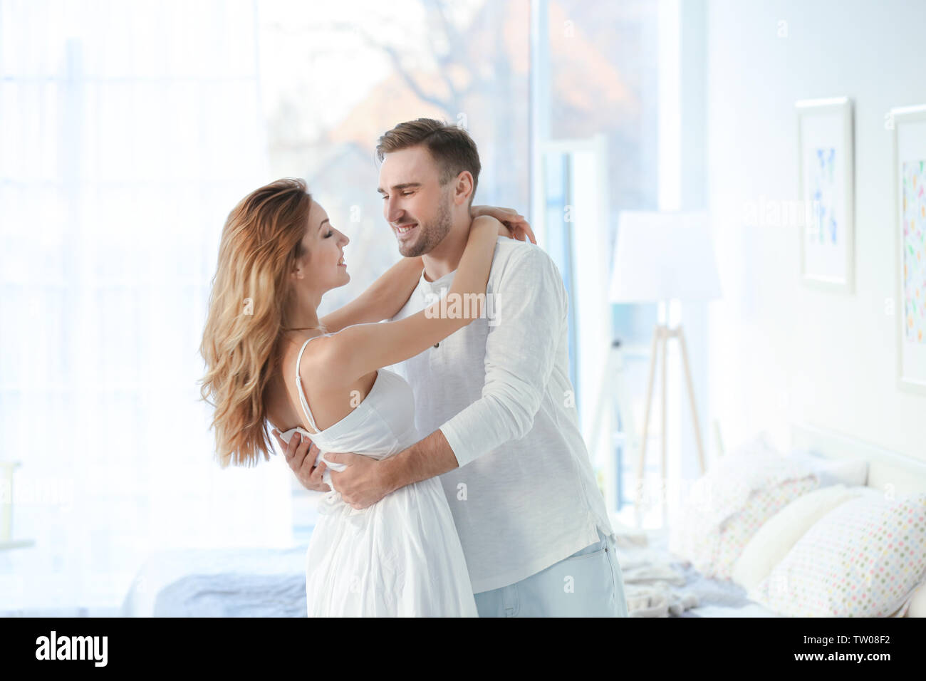 Cute young couple dancing at home Stock Photo - Alamy