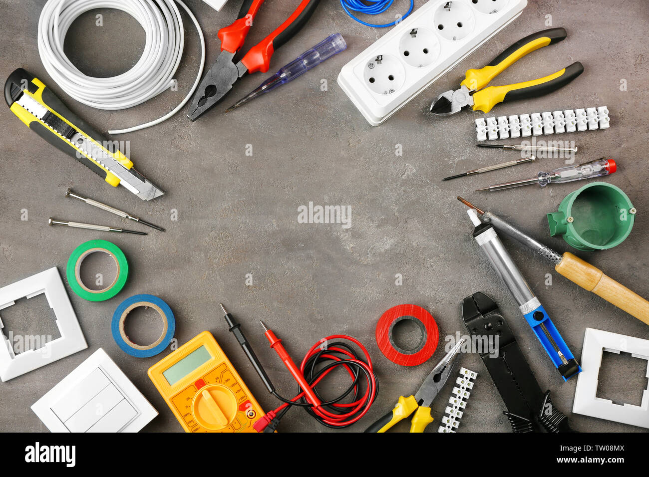 Different electrical tools on grey background Stock Photo - Alamy
