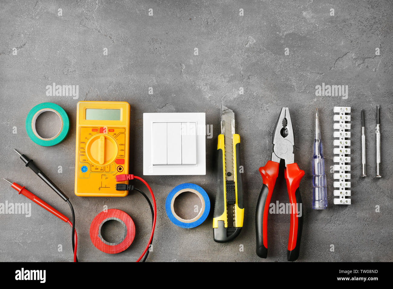 Different electrical tools on grey background Stock Photo - Alamy