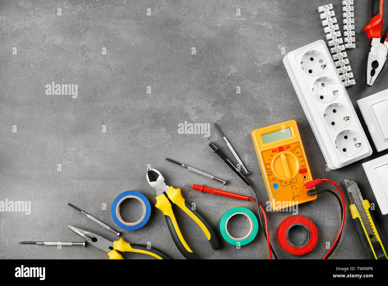 Different electrical tools on grey background Stock Photo - Alamy