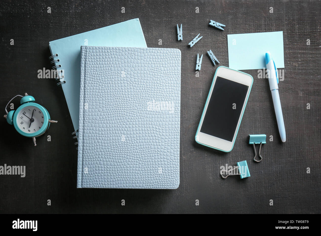 Notebooks and phone on black background Stock Photo - Alamy