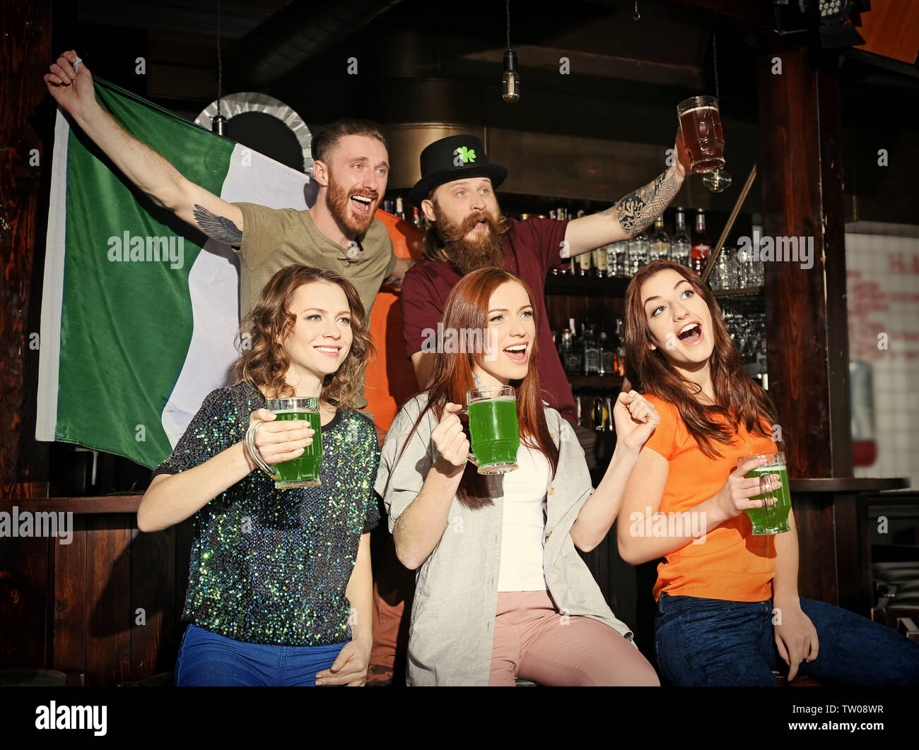 People celebrating Saint Patrick's Day in pub Stock Photo - Alamy