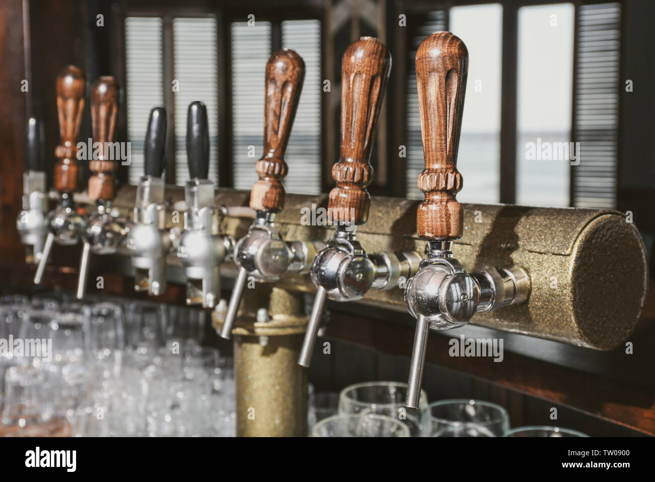 Draft beer taps in modern bar Stock Photo - Alamy