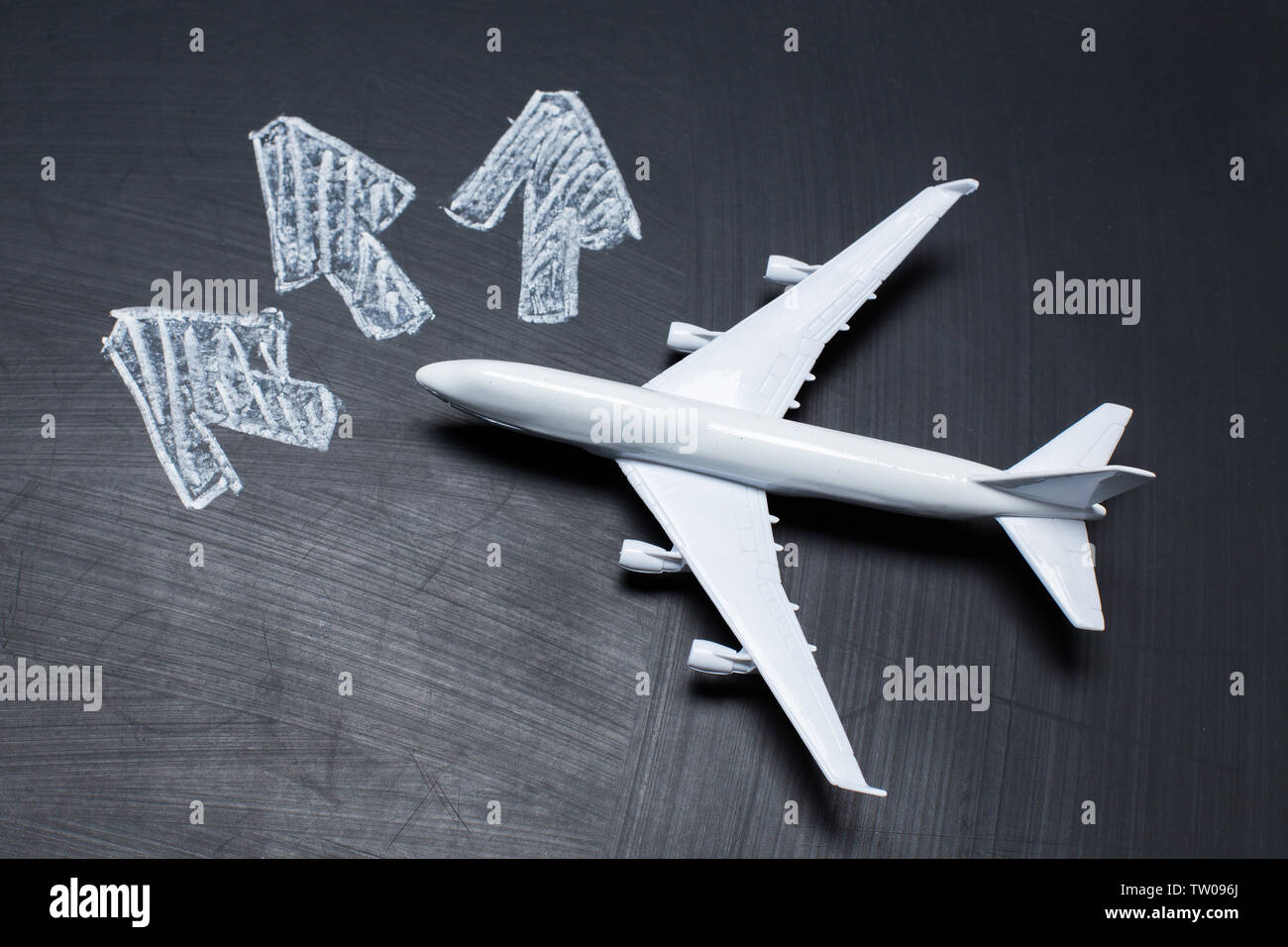 toy airplane over chalkboard background and arrows drawings Stock Photo ...