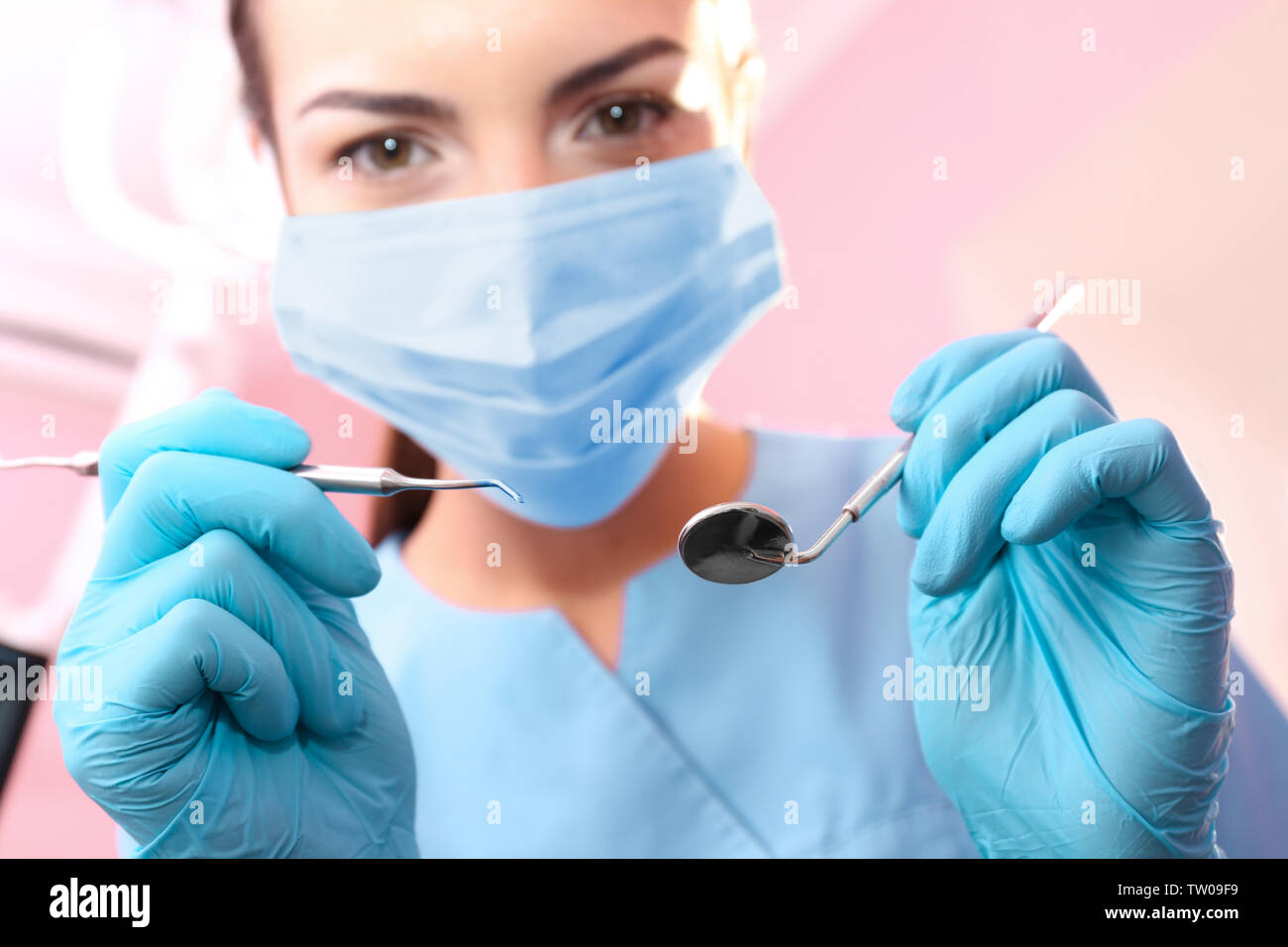 Dentist with mirror and periodontal explorer in clinic, closeup Stock ...