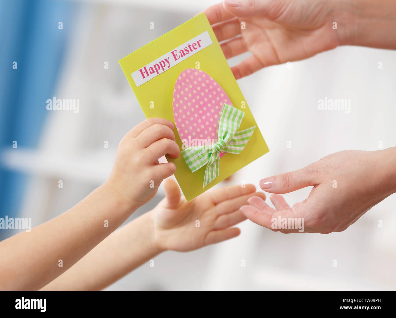 Little girl presenting handmade Easter card to her mother Stock Photo ...