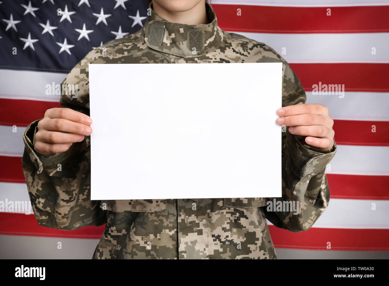 Female soldier with blank poster on flag background, closeup Stock ...