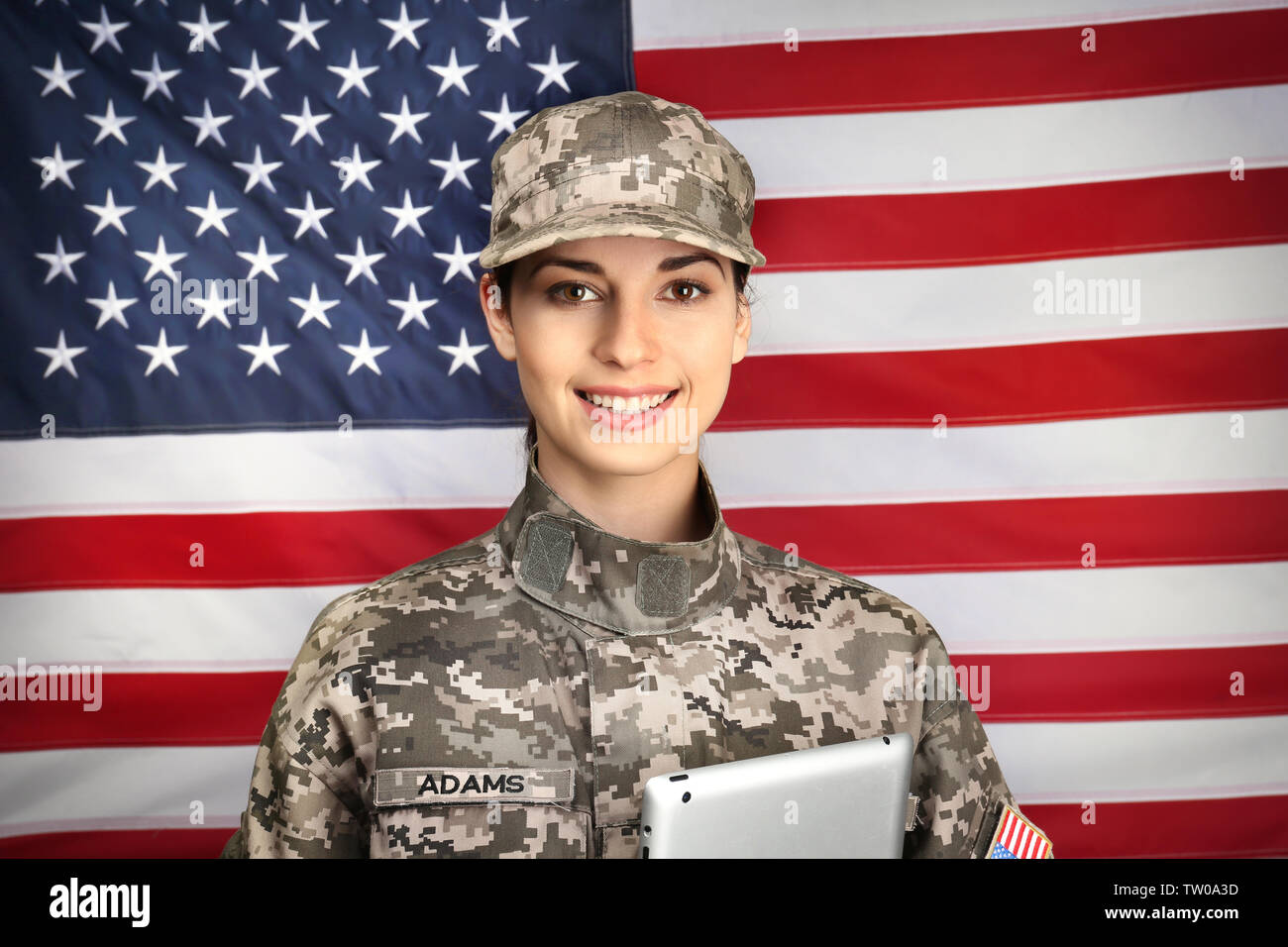 Female soldier with tablet on USA flag background Stock Photo - Alamy