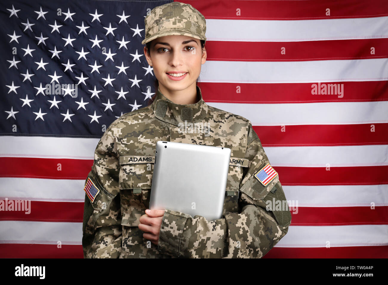 Female soldier with tablet on flag background Stock Photo - Alamy