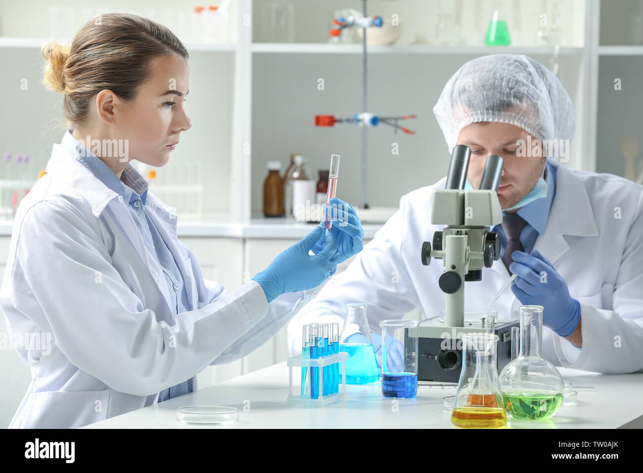 Scientists working reagents in laboratory hi-res stock photography and ...