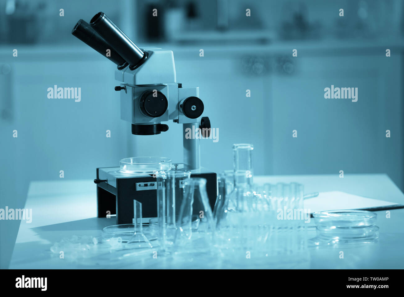 Microscope and test tubes in laboratory Stock Photo - Alamy