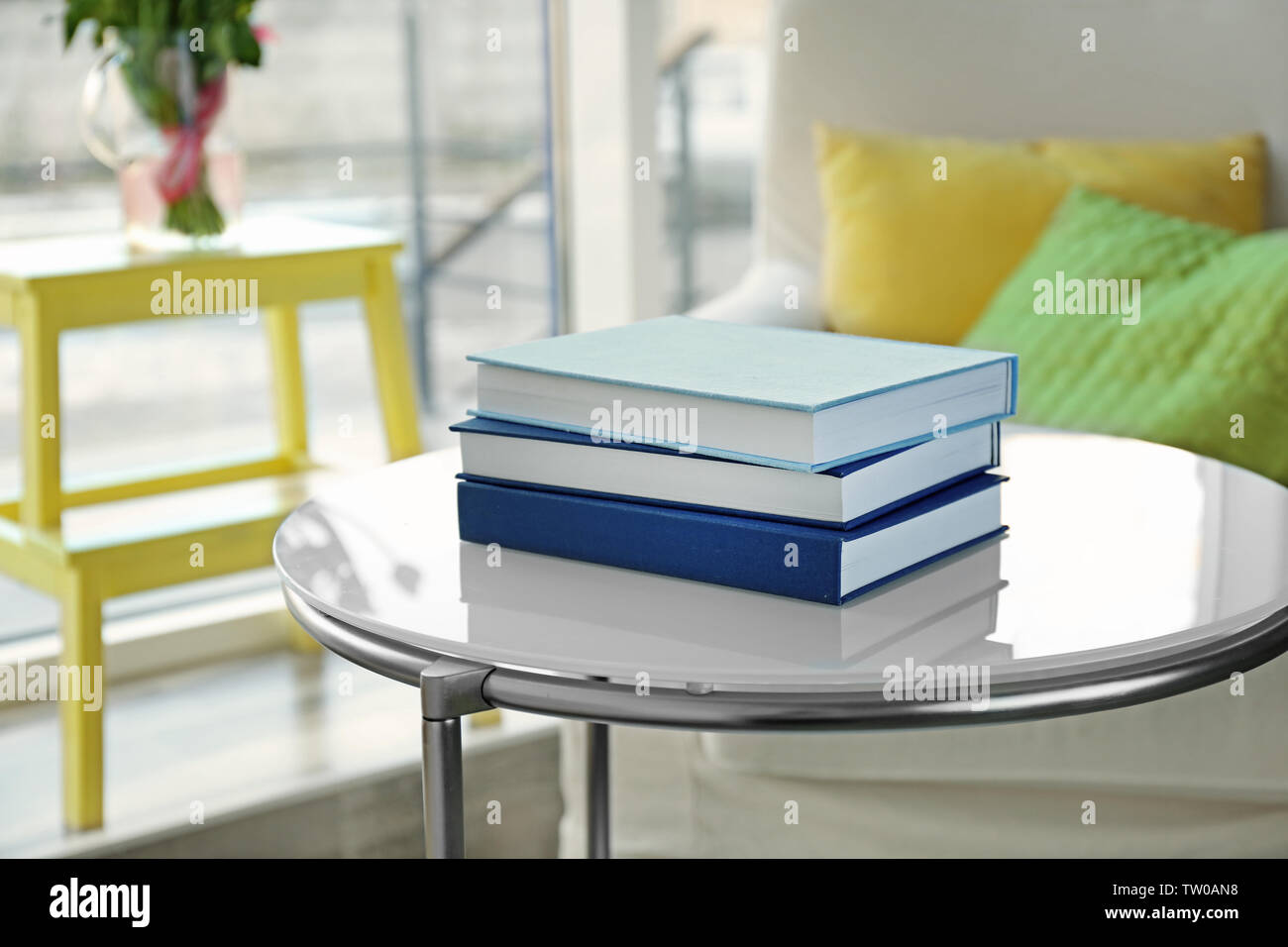 Pile of books on table at home Stock Photo - Alamy