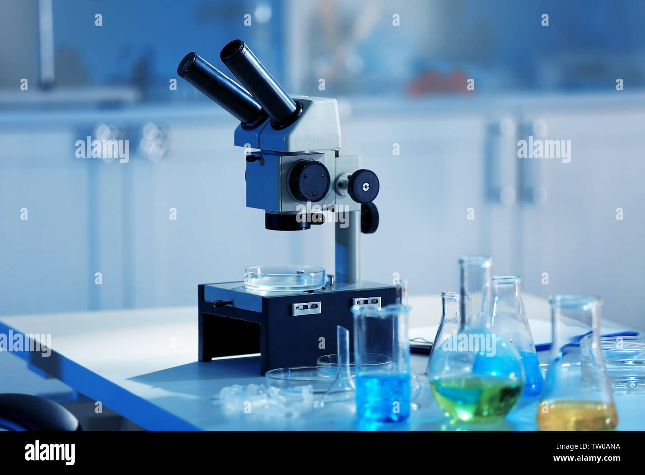 Microscope and test tubes in laboratory Stock Photo - Alamy