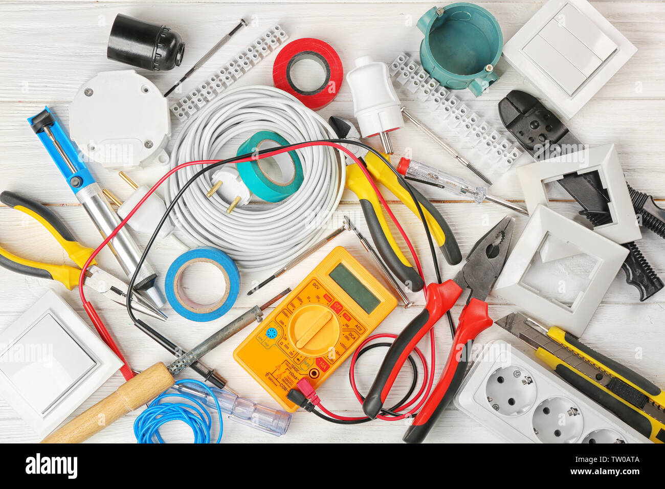 Electrician tools on wooden background Stock Photo - Alamy