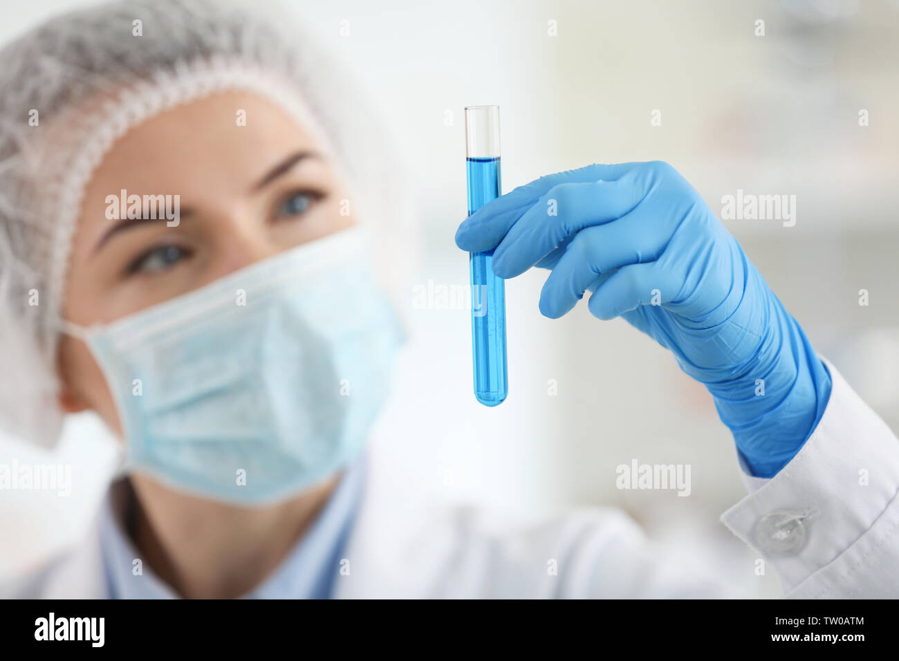 Scientist holding test tube with sample in laboratory Stock Photo - Alamy