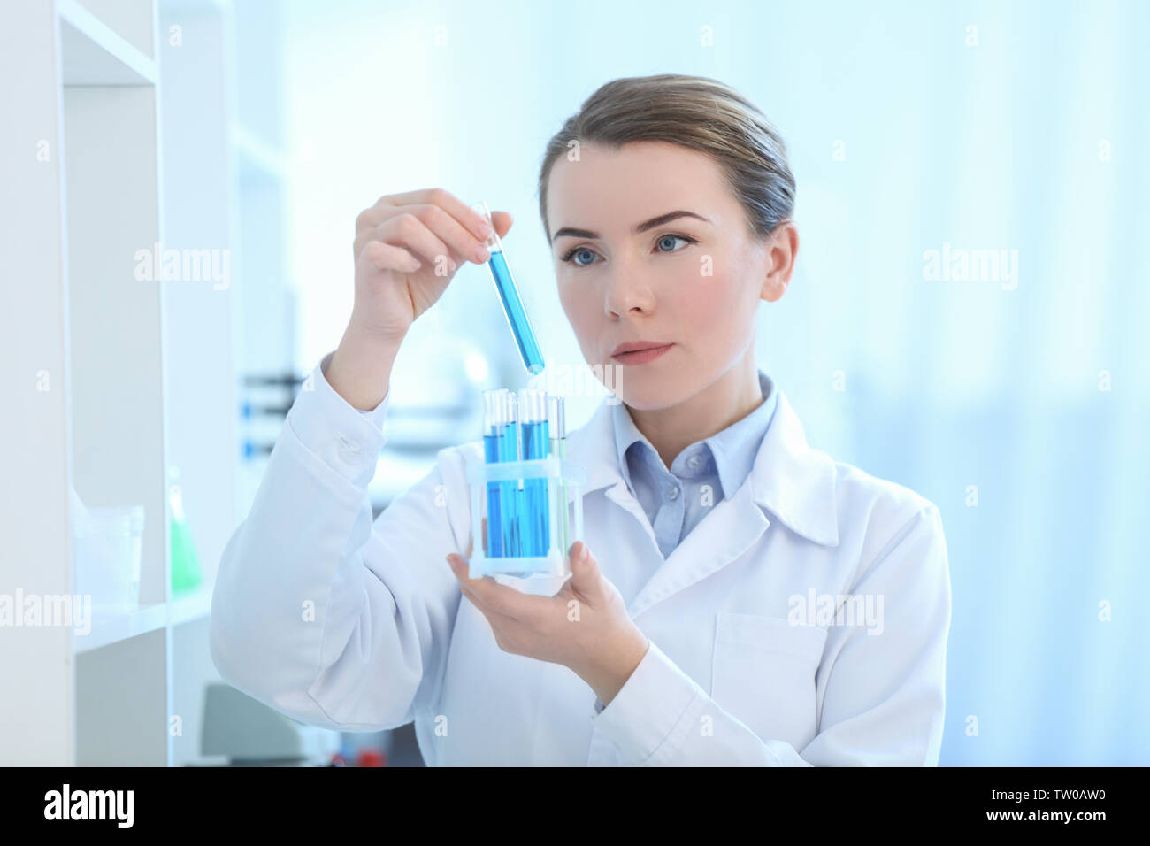 Scientist holding test tube with sample in laboratory Stock Photo - Alamy